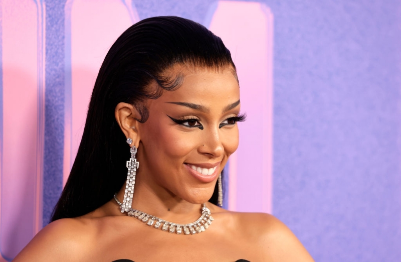 Doja Cat Poses For Photos In A Barbie-Pink Bikini & Tons Of Accessories